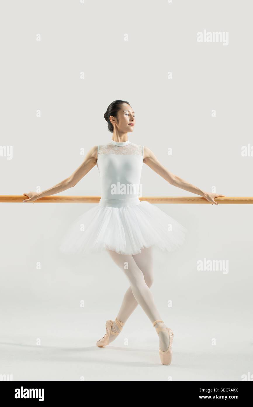 a ballet dancer practicing at the barre Stock Photo - Alamy