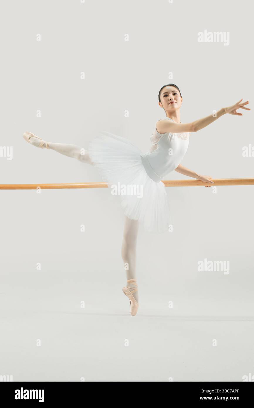 a ballet dancer practicing at the barre Stock Photo - Alamy