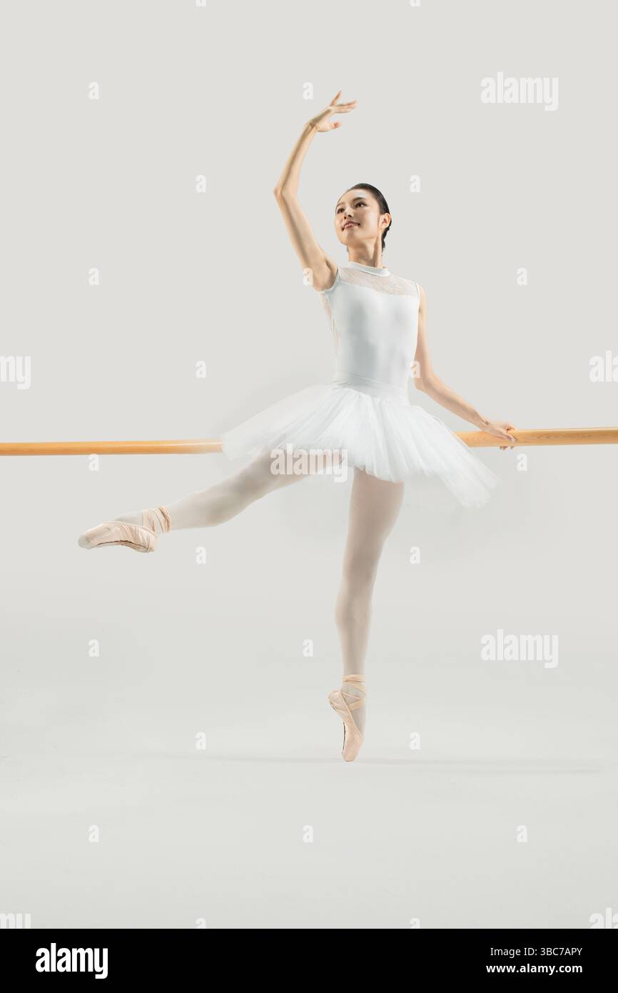 a ballet dancer practicing at the barre Stock Photo - Alamy