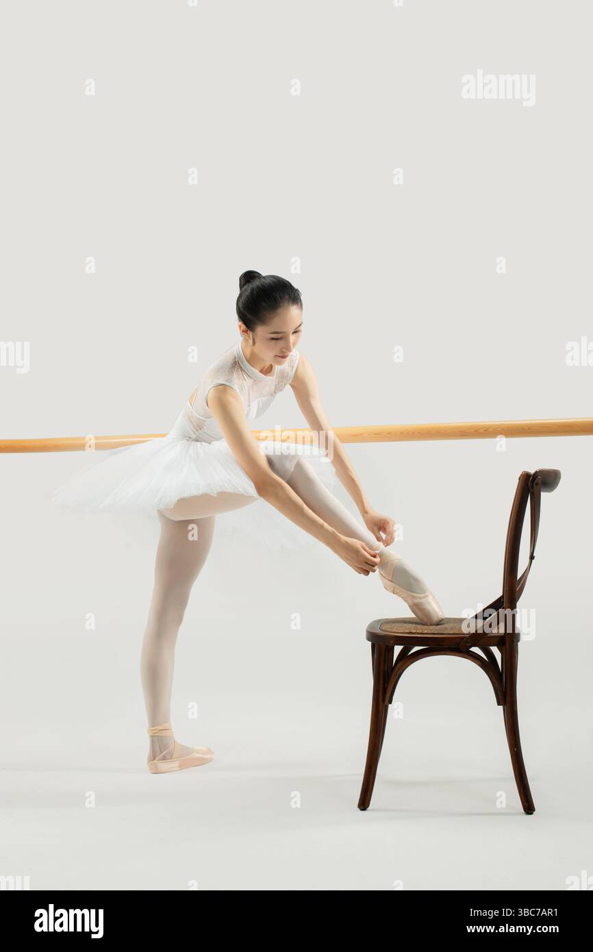 a ballet dancer leaning on a chair while dancing Stock Photo - Alamy