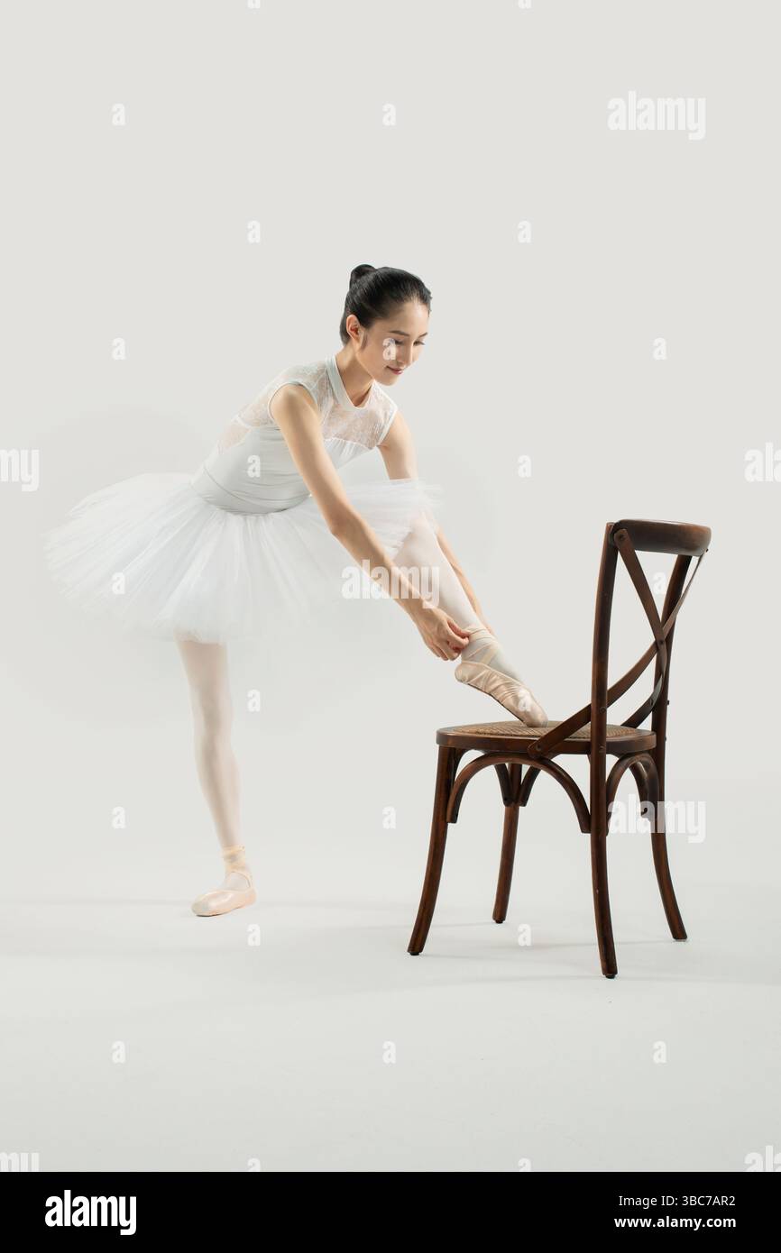 a ballet dancer leaning on a chair while dancing Stock Photo - Alamy