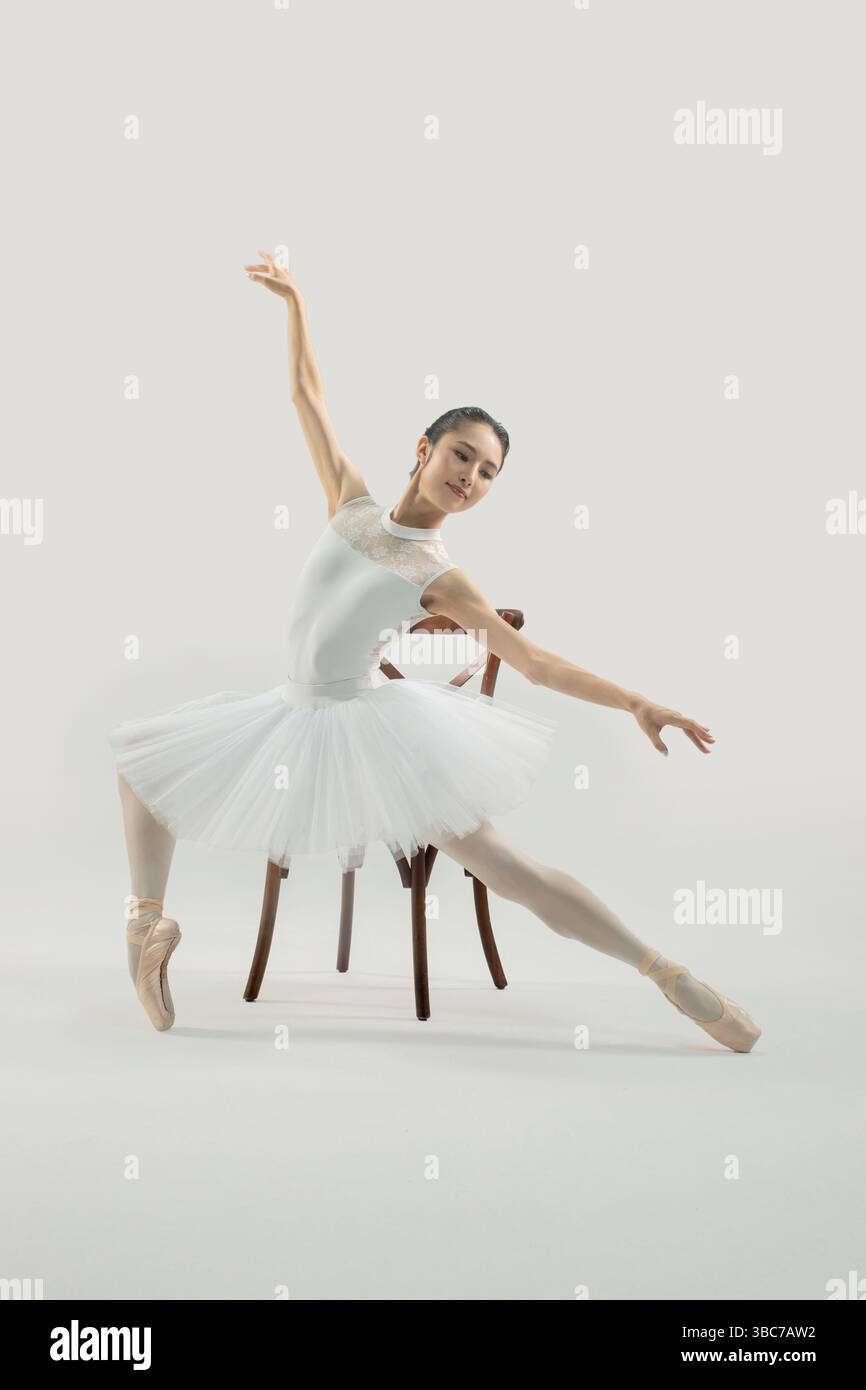 a ballet dancer leaning on a chair while dancing Stock Photo - Alamy