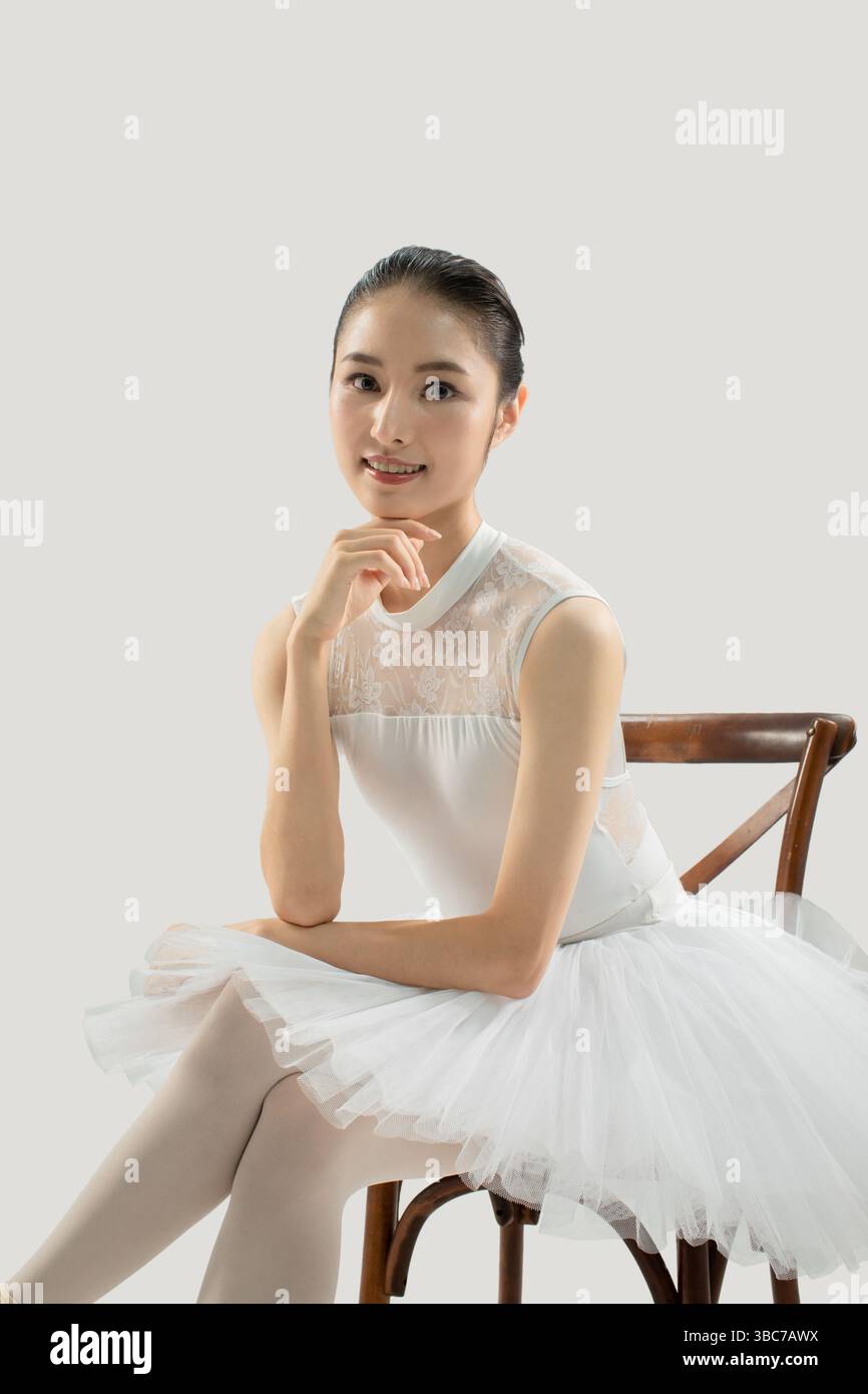 a ballet dancer leaning on a chair while dancing Stock Photo - Alamy