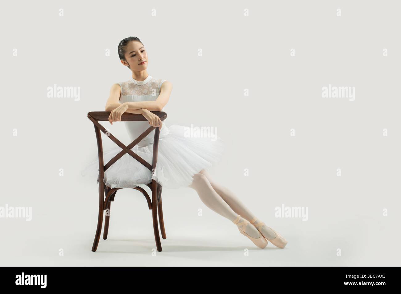 a ballet dancer leaning on a chair while dancing Stock Photo - Alamy