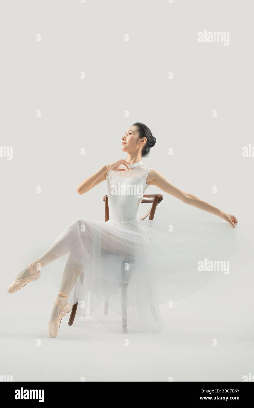 a ballet dancer leaning on a chair while dancing Stock Photo - Alamy