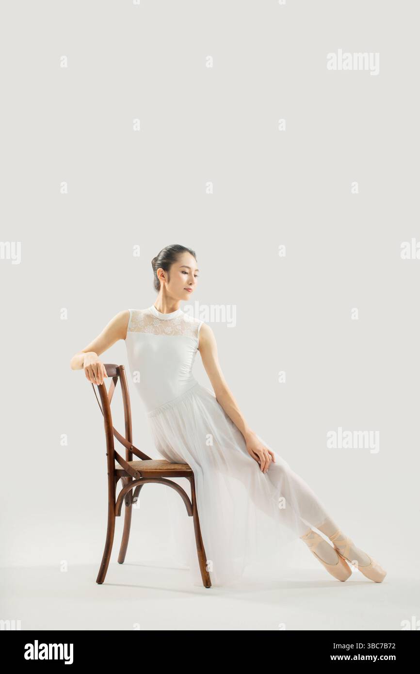 a ballet dancer leaning on a chair while dancing Stock Photo - Alamy