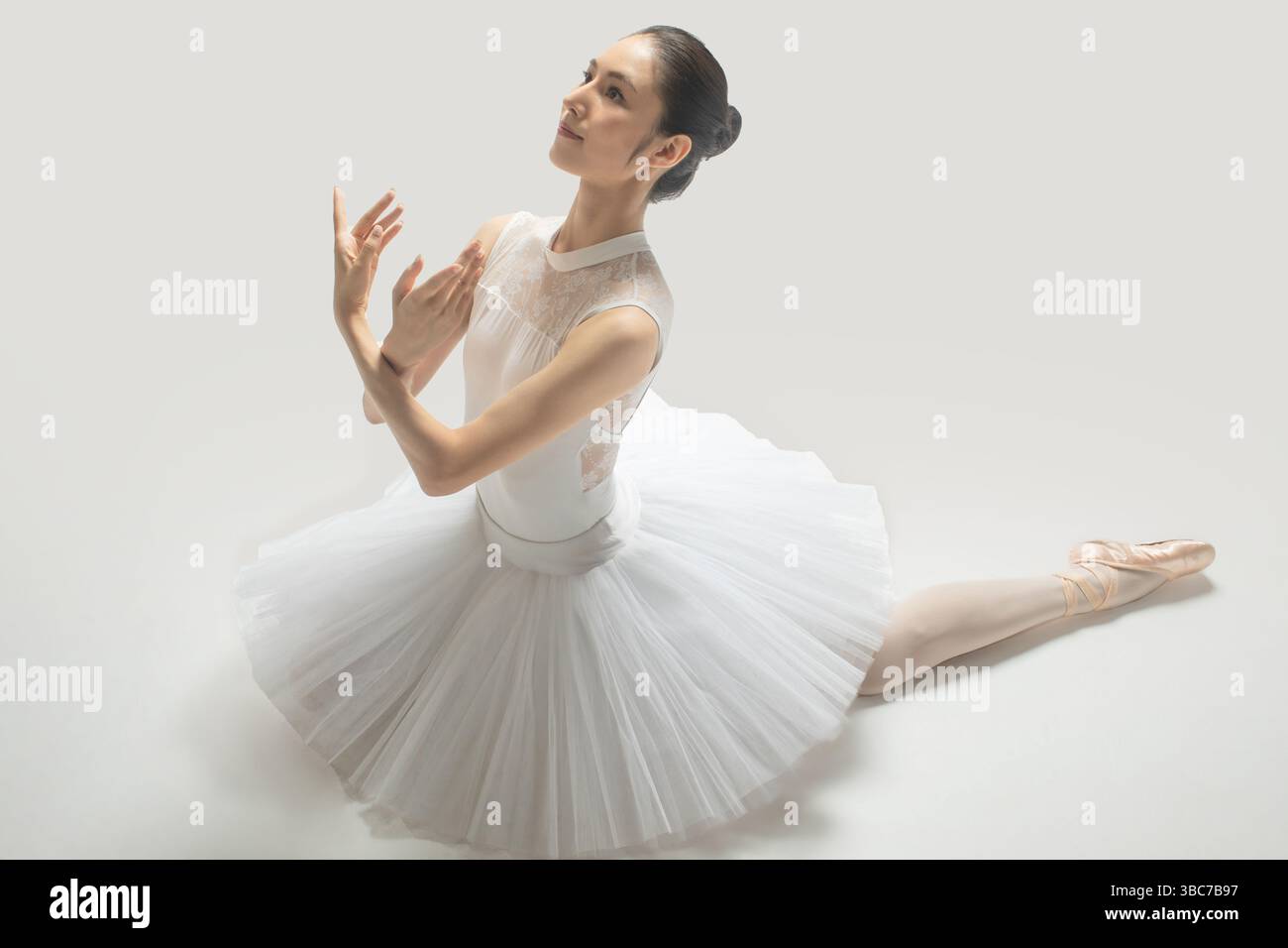 a ballet dancer sitting on the floor Stock Photo - Alamy