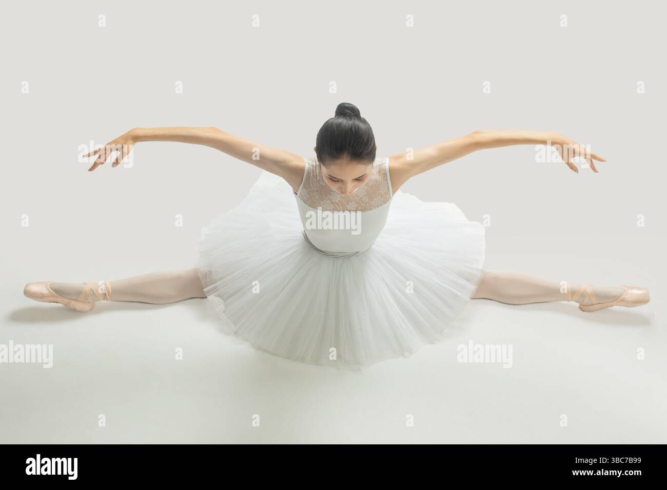 a ballet dancer sitting on the floor Stock Photo - Alamy