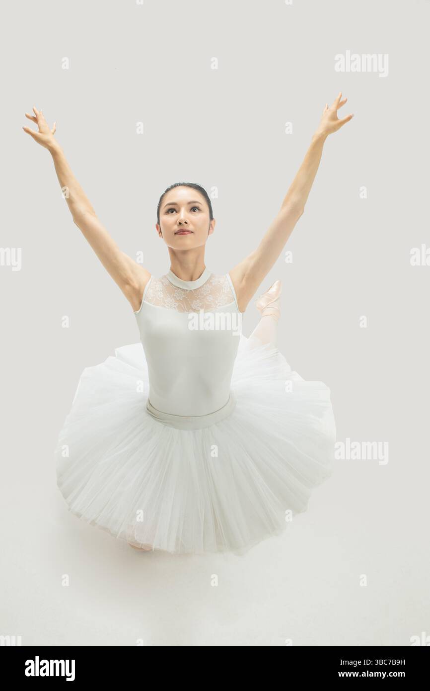 a ballet dancer sitting on the floor Stock Photo - Alamy