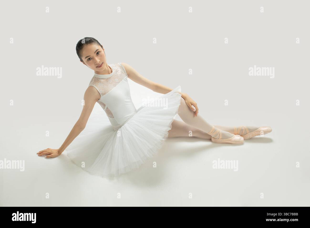 a ballet dancer sitting on the floor Stock Photo - Alamy
