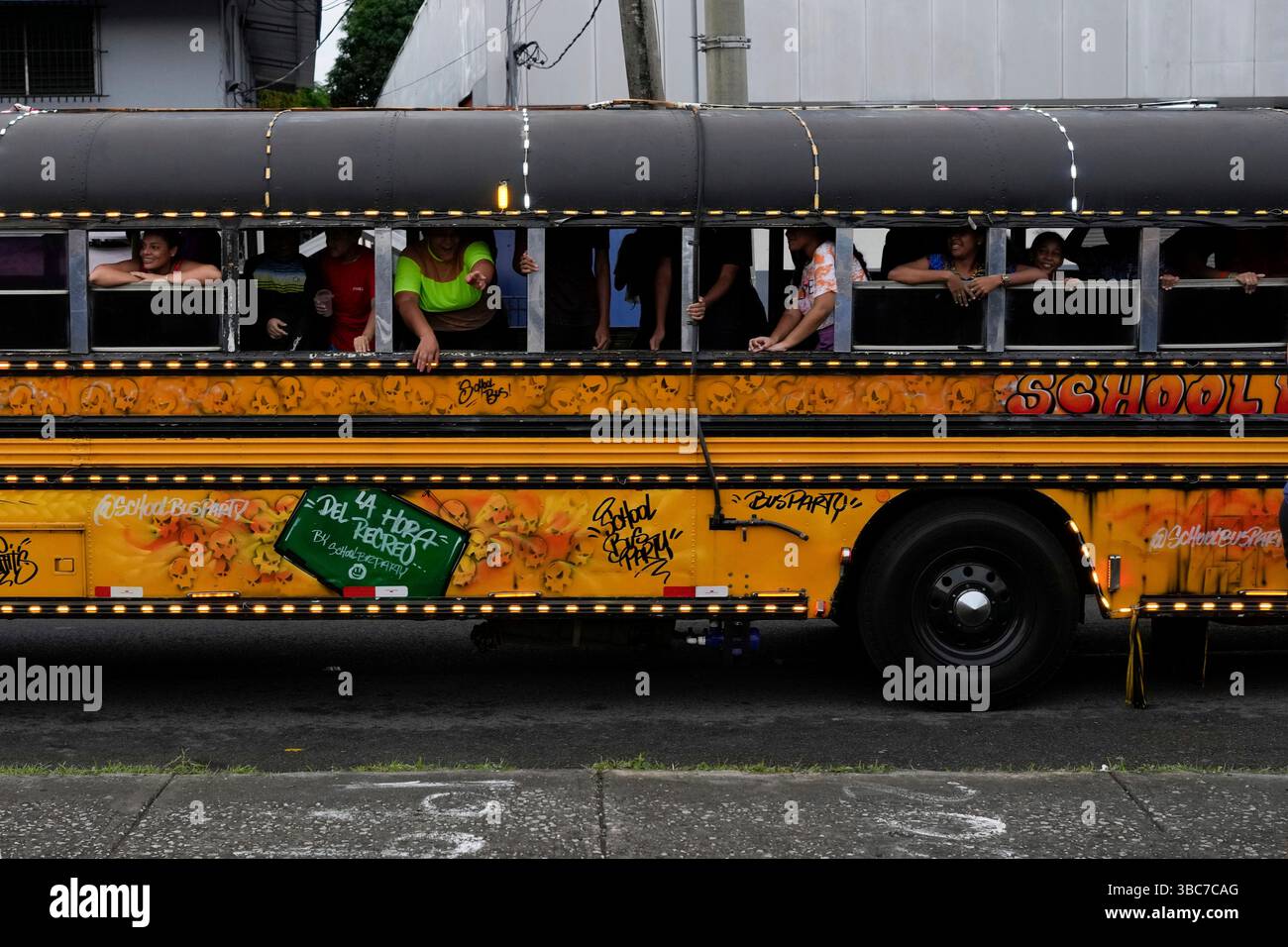 Party goers ride on a Red Devil party bus in Panama City, Sunday, Aug ...
