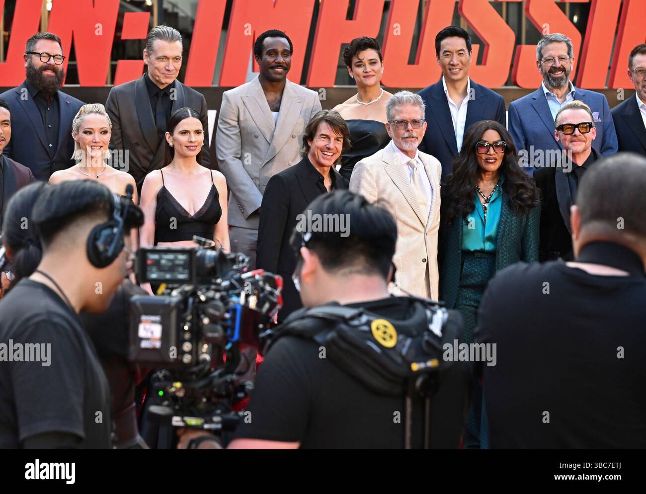 Tom Crusie, center, and members of the cast pose together at the ...