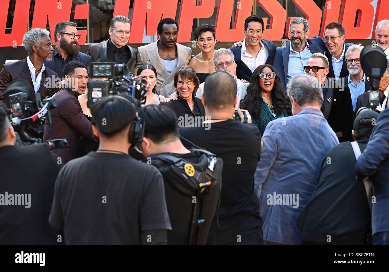 Tom Crusie, center, and members of the cast pose together at the ...