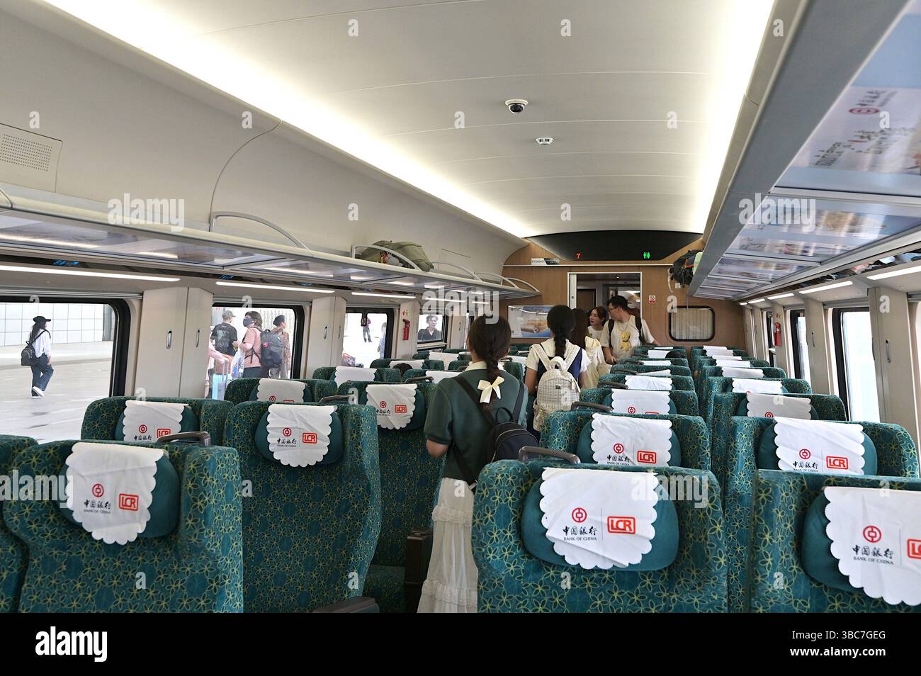 Passengers making their way to their seats in a Laos-China high-speed ...