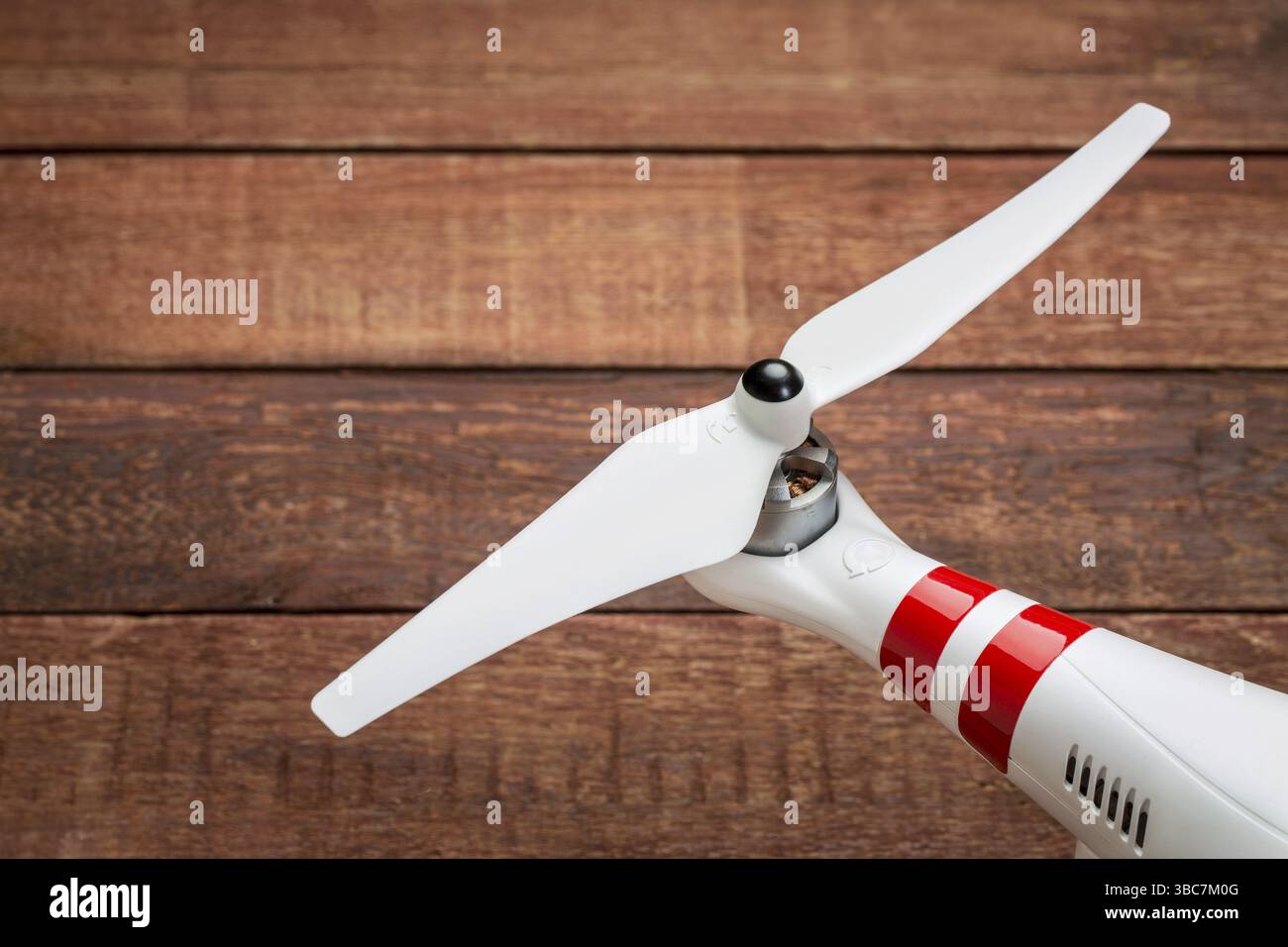 Flexible, plastic propeller of a small drone (quadcopter) against red ...