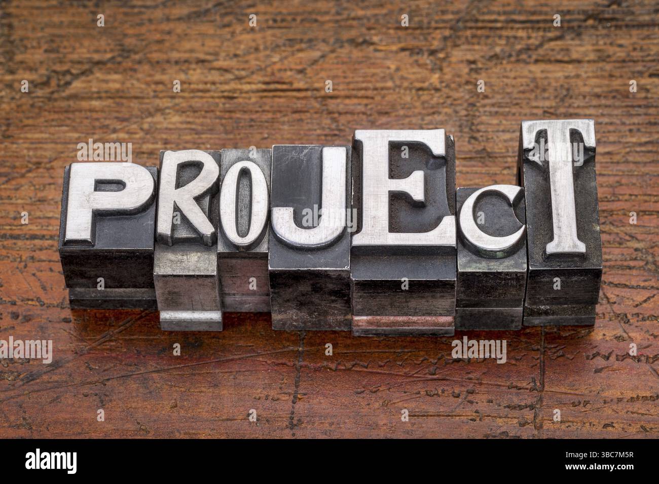 Project word in mixed vintage metal type printing blocks over grunge ...