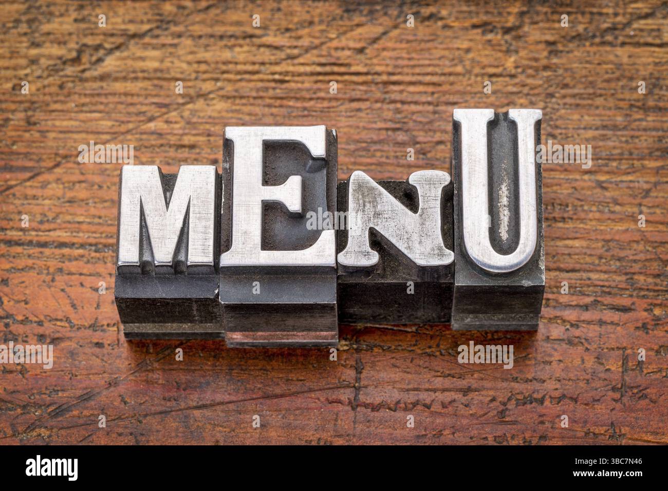 Menu word in vintage metal type printing blocks over grunge wood Stock ...