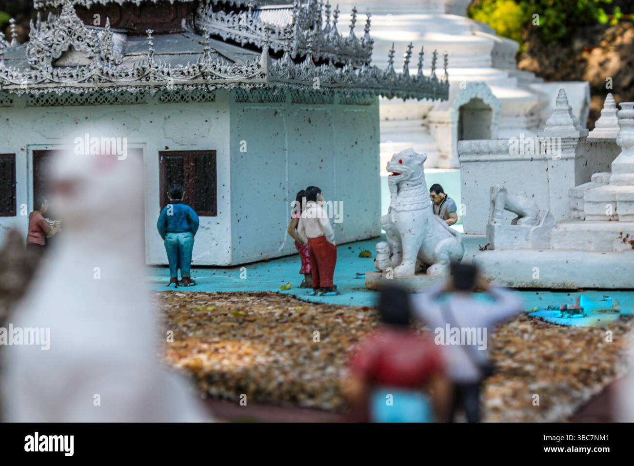 Miniature Temple Scene with Figurines and Guardian Lion Statue Stock ...