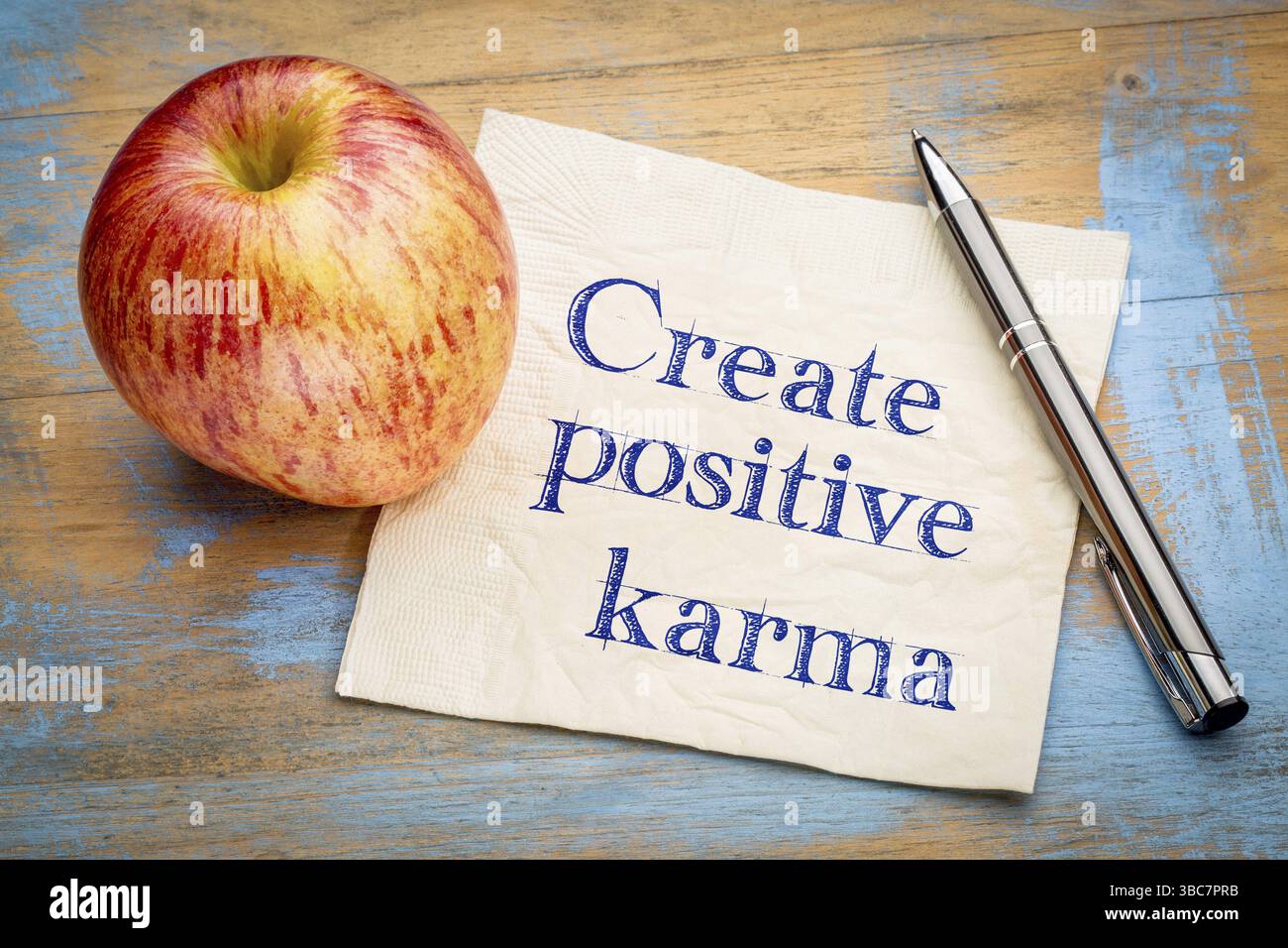 Create positive karma - motivational handwriting on a napkin with apple ...