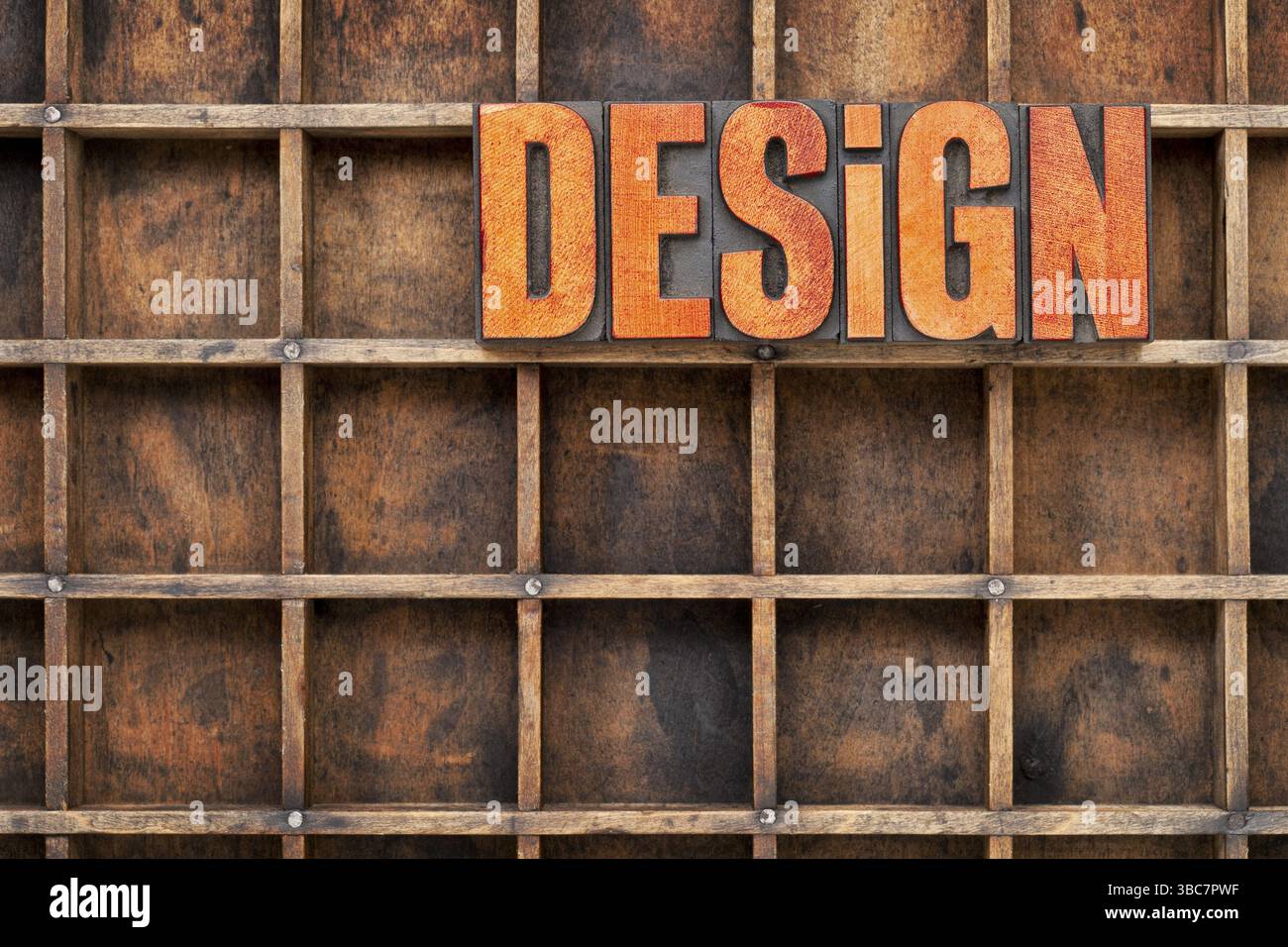 Design word in vintage letterpress wood type blocks stained by red ink ...