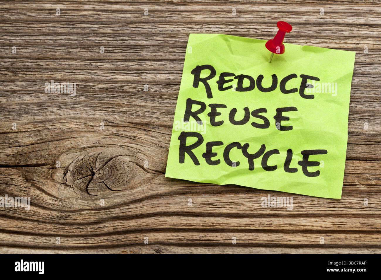 Reduce, reuse and recycle reminder note against grained wood - resource conservation concept ...