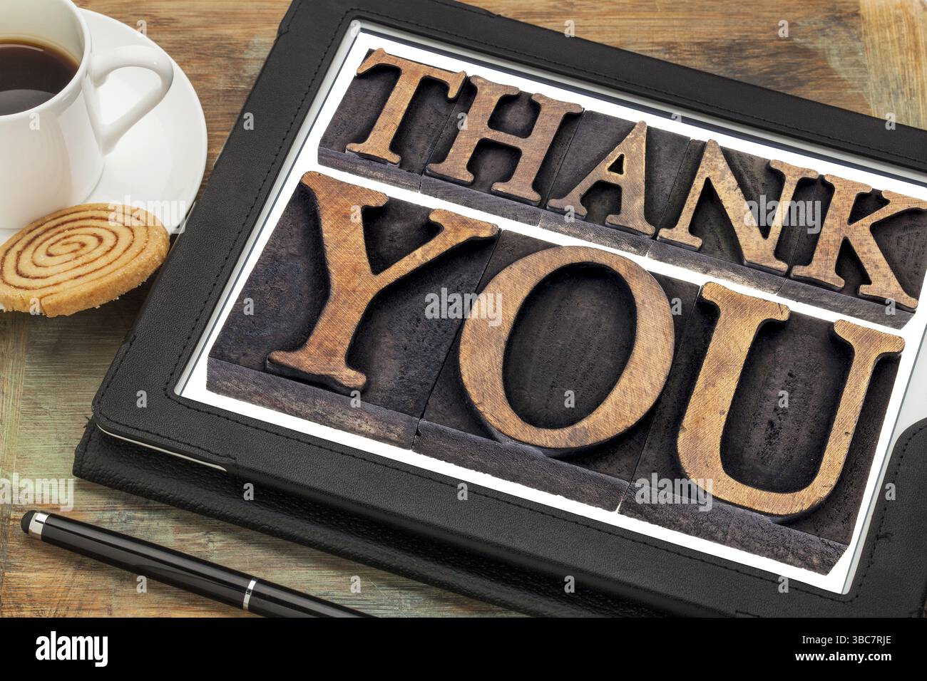 Thank you - text in vintage letterpress wood type on a digital tablet ...