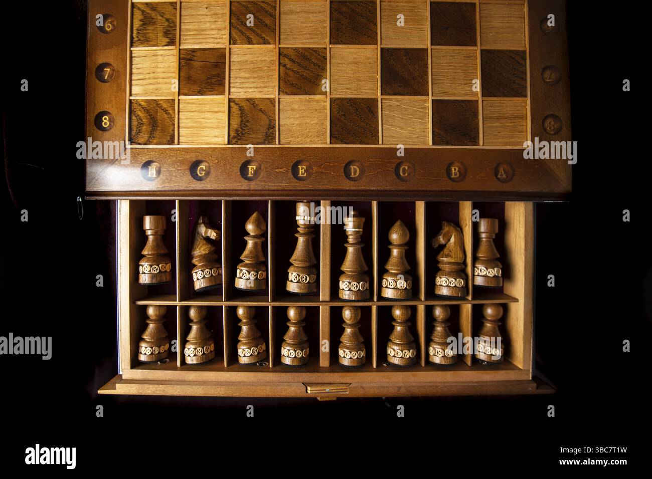 Dark chess pieces lie in a box. A puzzle game with tricky combinations ...