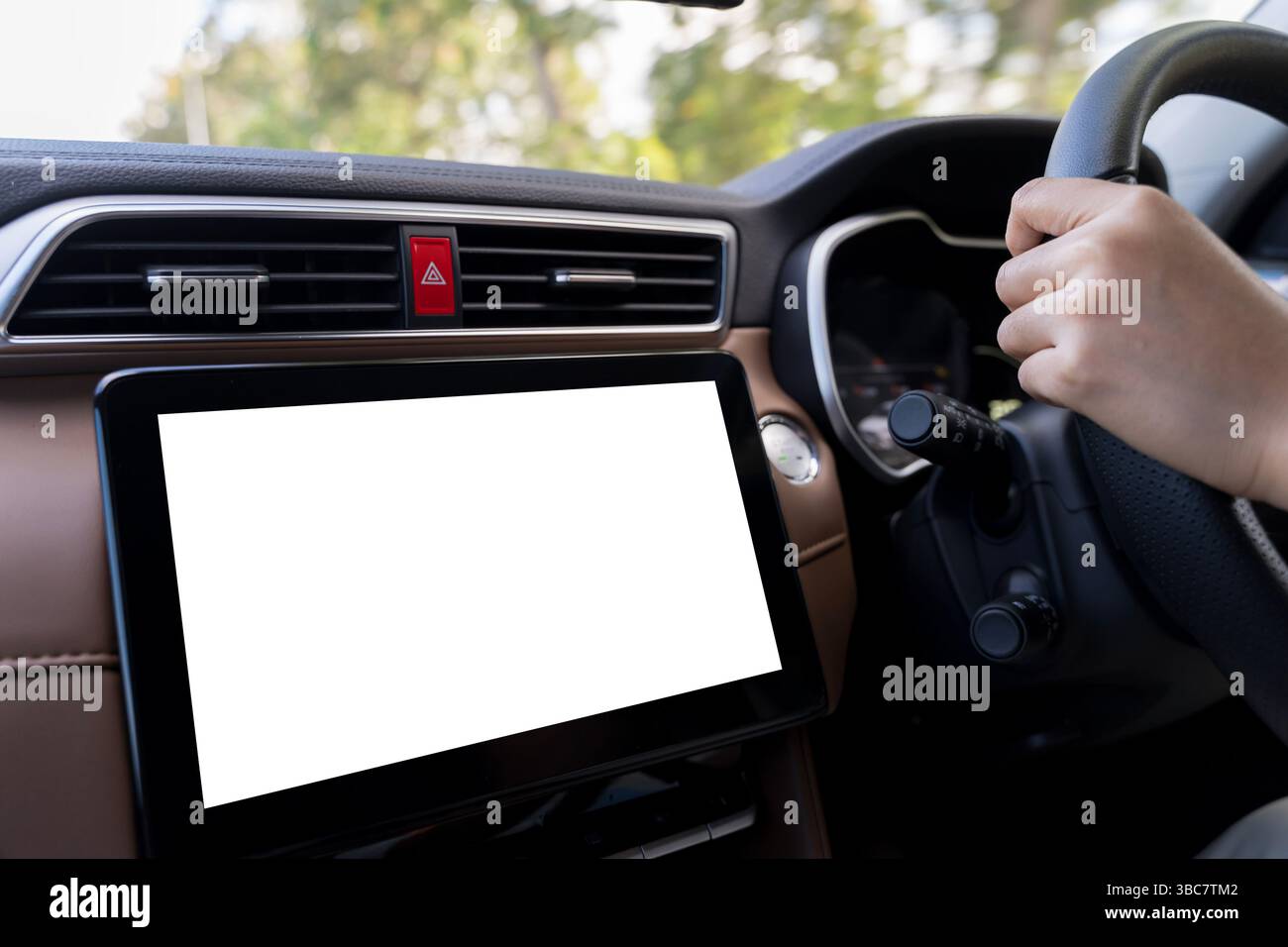 Close-up of blank white touchscreen in car dashboard with driver hand ...