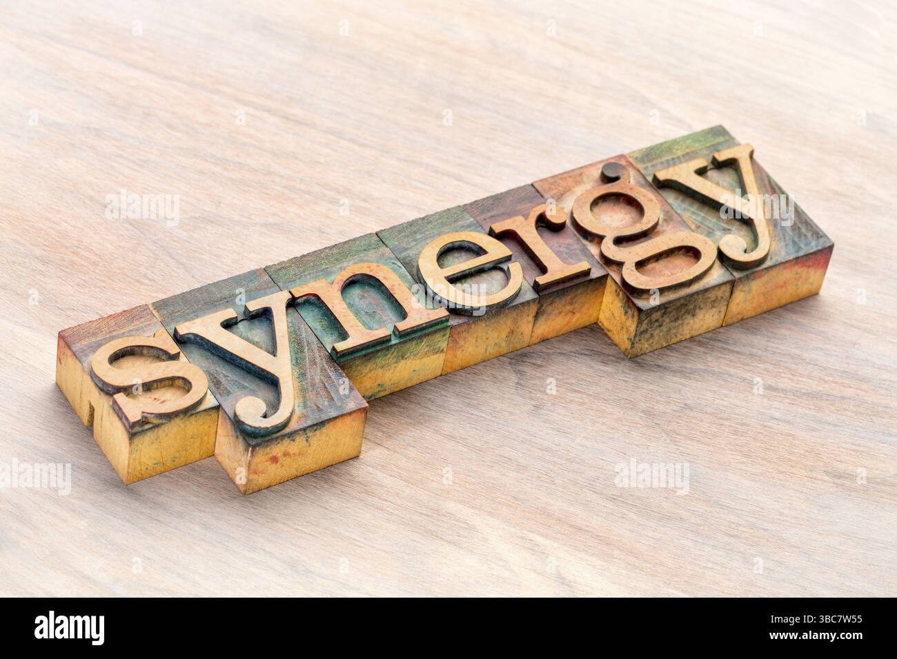 Synergy word abstract in letterpress wood type blocks stained by color ...