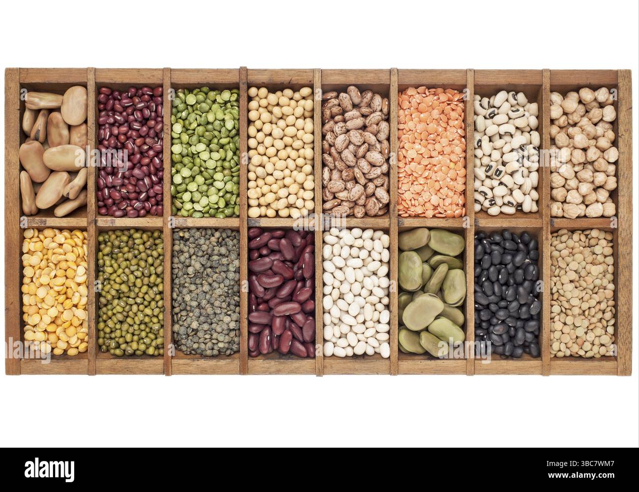 Old wooden typesetter box with 16 samples of assorted legumes: green ...