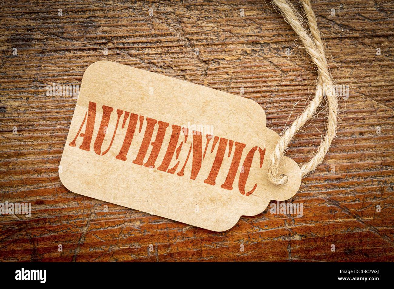 Authentic sign - red stencil text on a cardboard price tag against ...