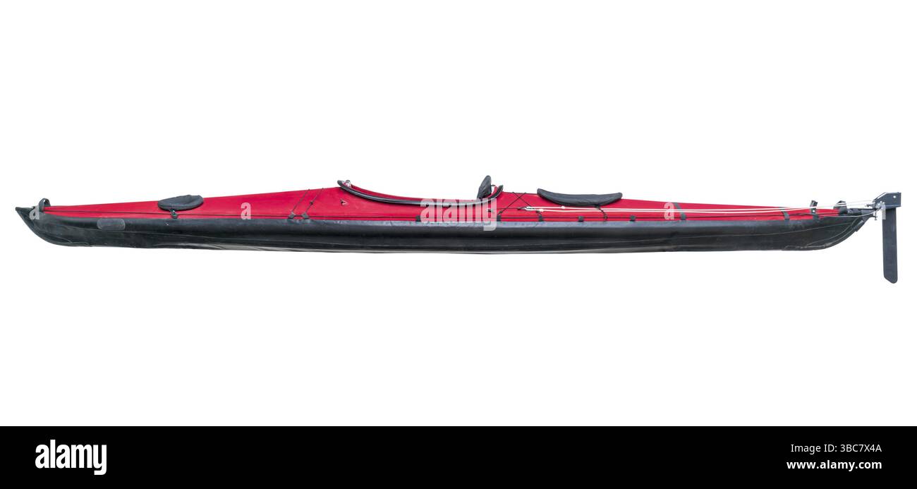 A side view of a folding sea kayak with a red deck and rudder isolated ...