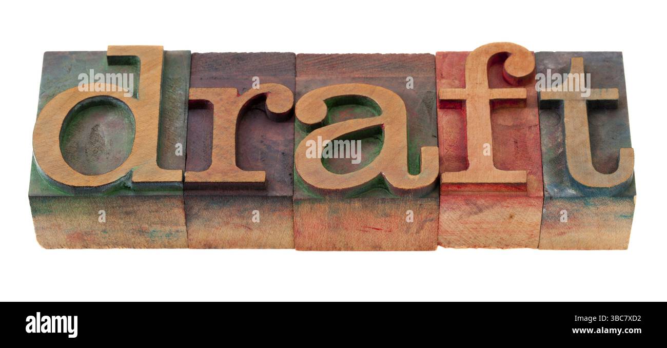 Draft word in vintage wooden letterpress printing blocks, stained by ...