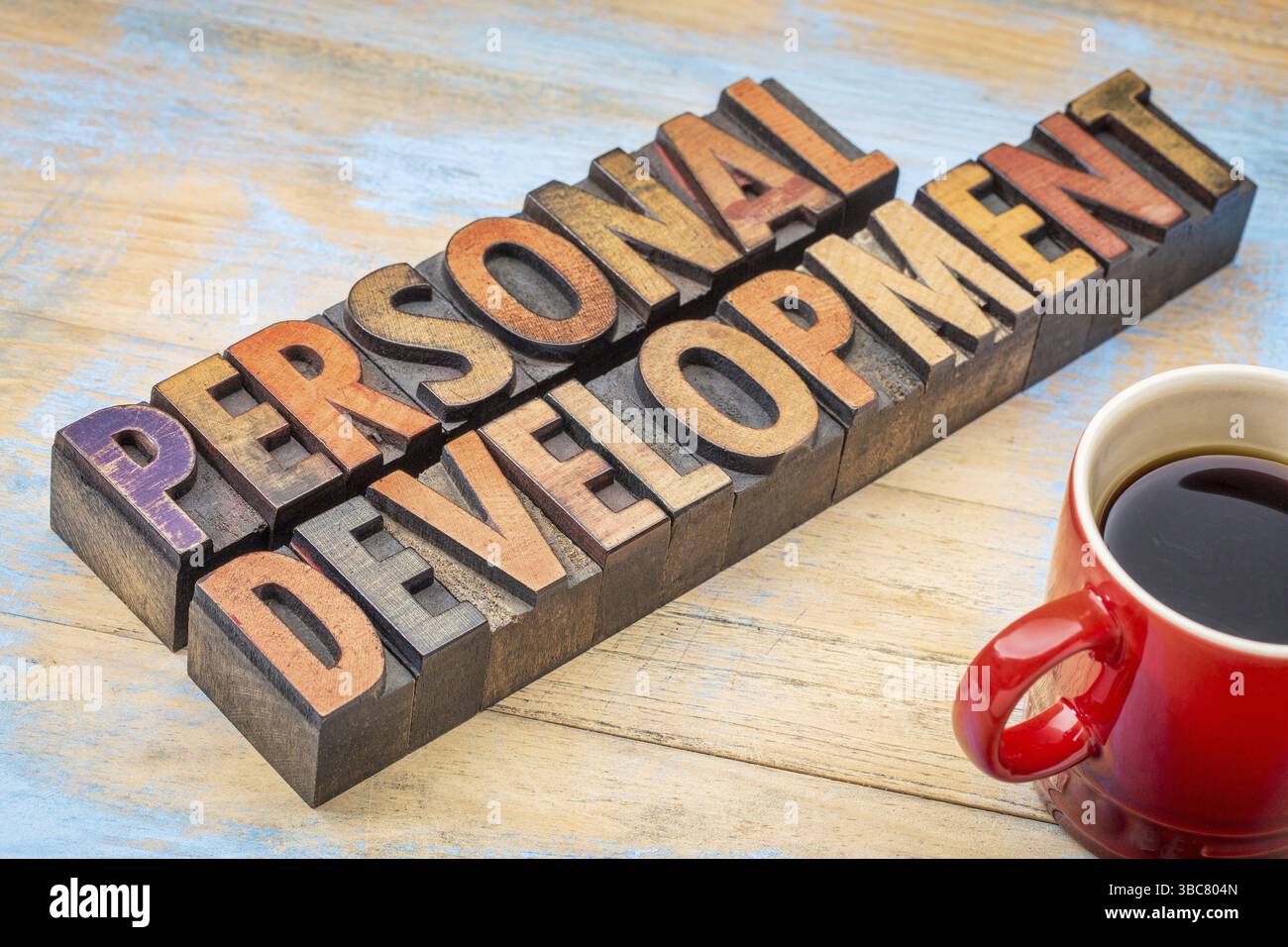 Personal development - text in vintage letterpress wood type with a cup ...
