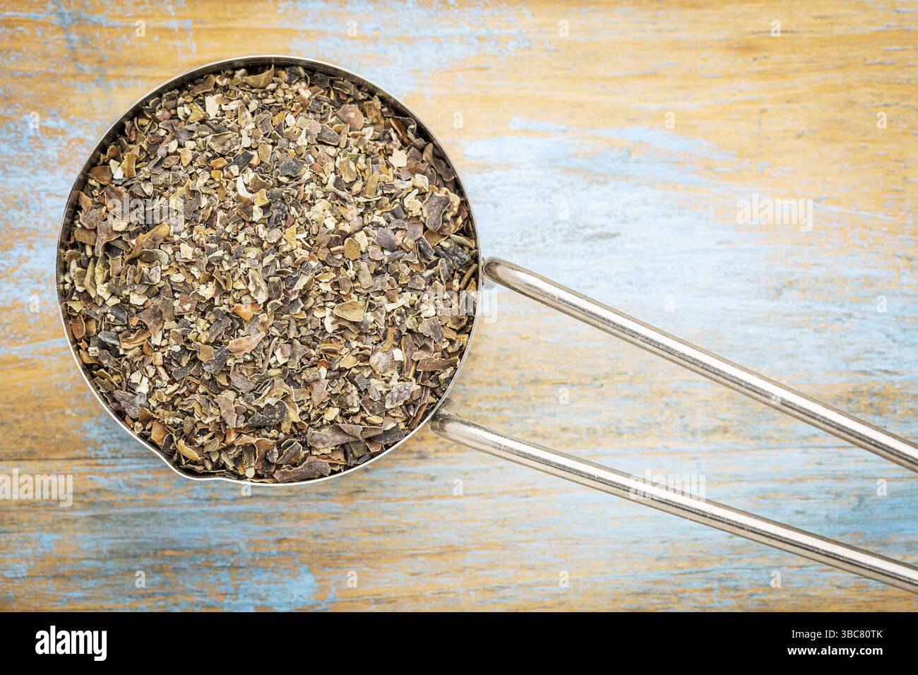 Bladderwrack seaweed flakes - top view of a metal measuring scoop ...