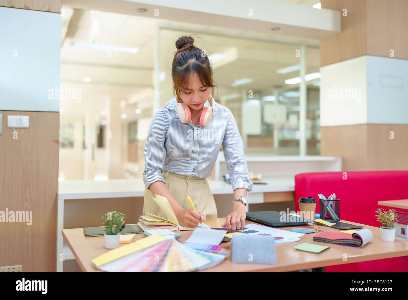 Asian woman interior designer at work, sketching ideas with color ...