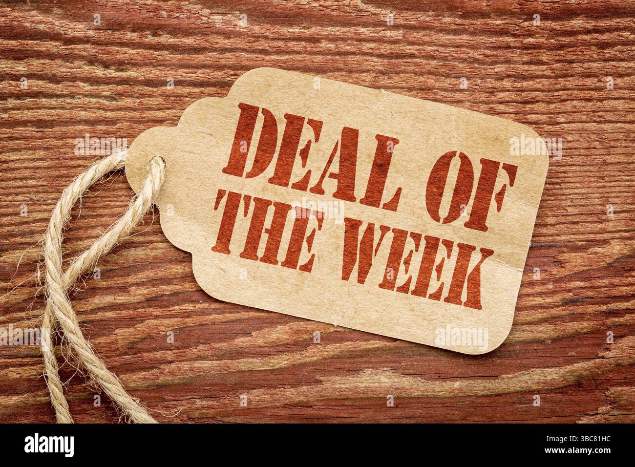 Deal of the week sign a paper price tag against rustic red painted barn ...