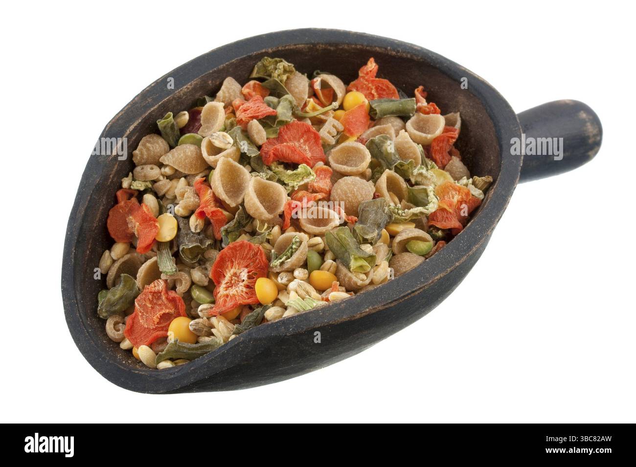 A rustic, wooden scoop of vegetable soup mix including whole wheat ...