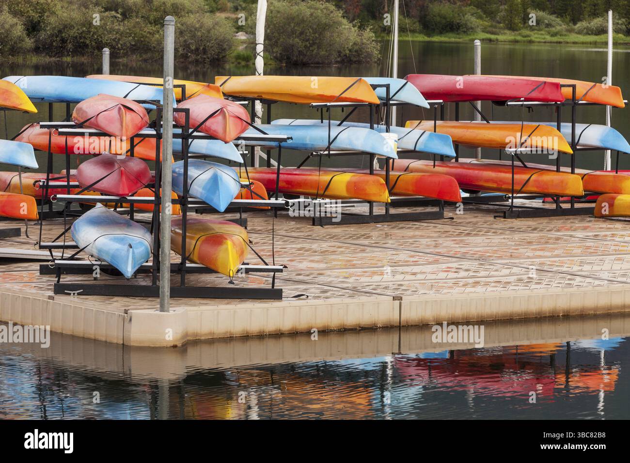 Colorful plastic recreational and sea kayaks on a floating dock with ...