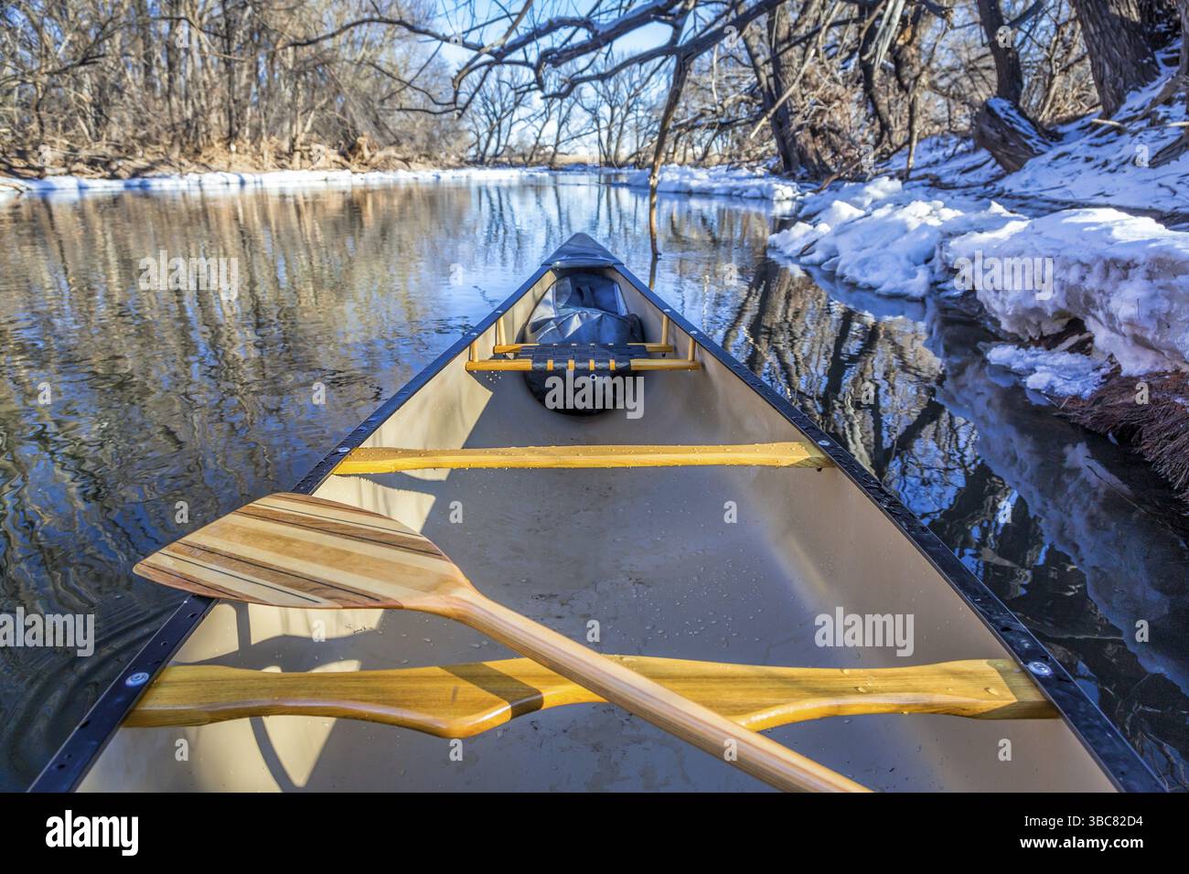 View from a canoe paddling on a river in winter scenery Stock Photo - Alamy