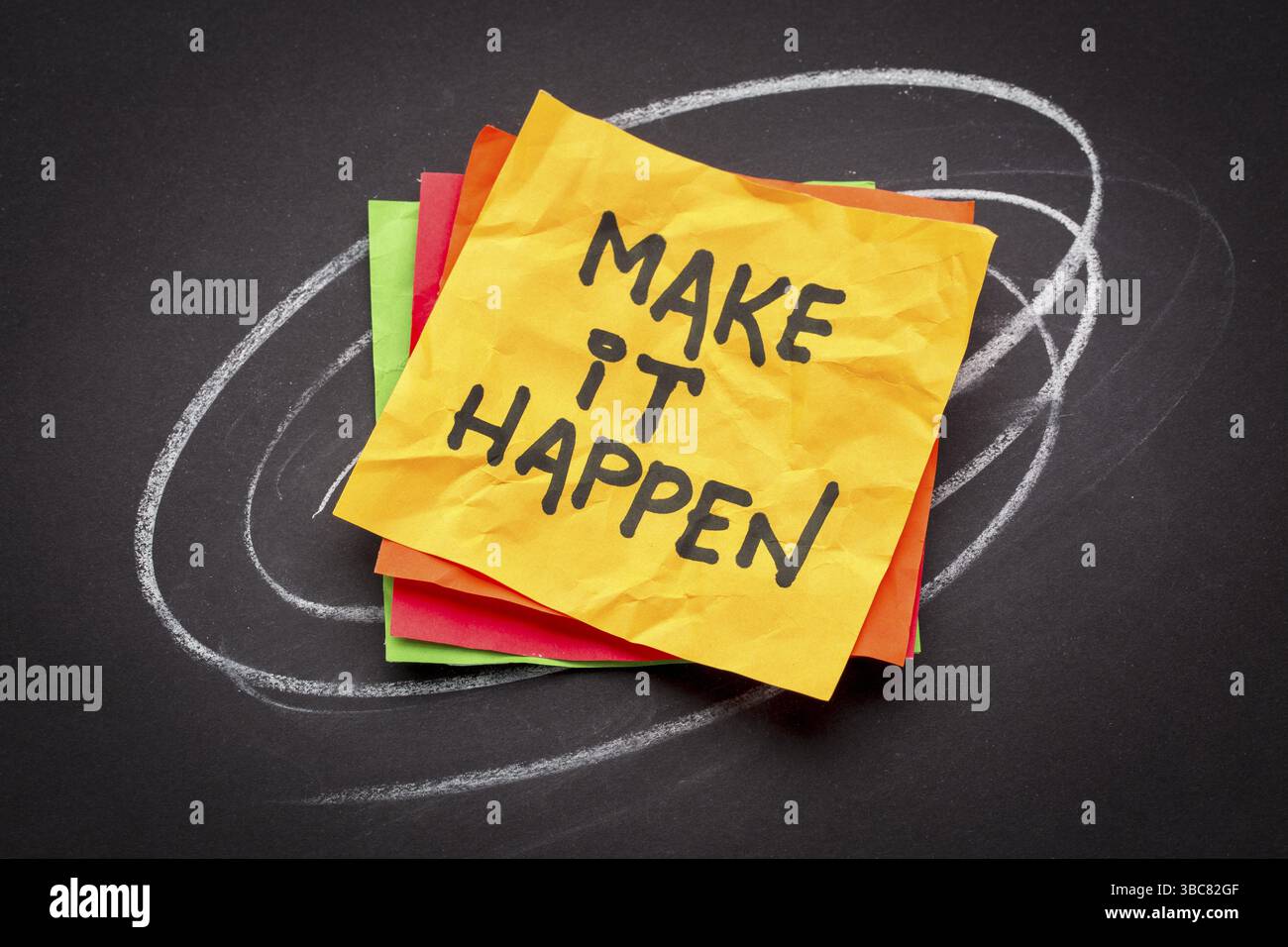 Make it happen, motivational slogan, colorful sticky notes against ...