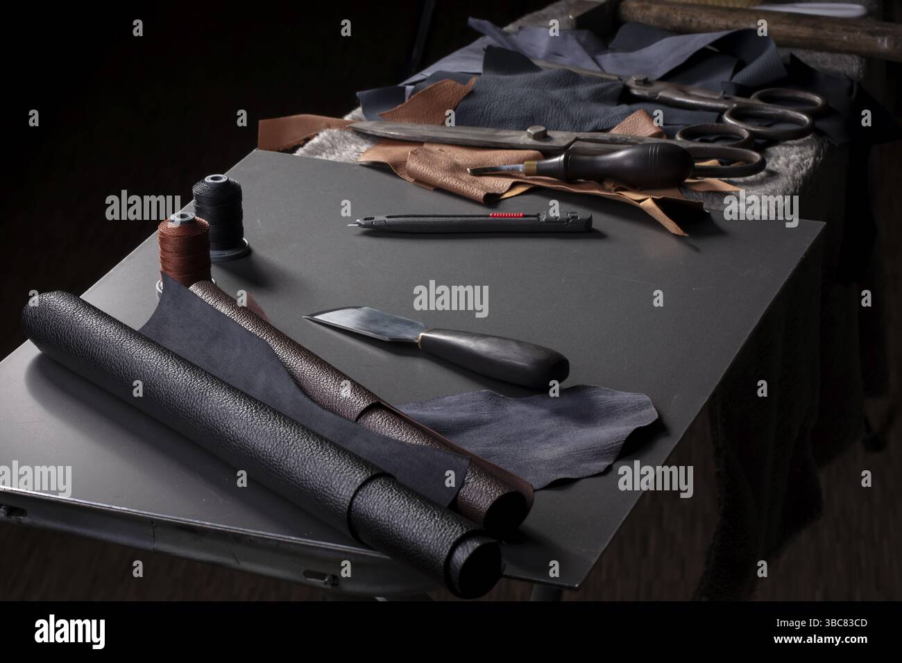 Work table with the tools of a craftsman for the production of leather ...
