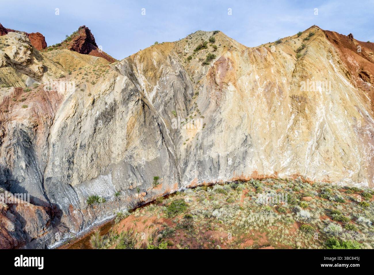 Aerial view of colorful rock formation and steep cliff along Onion ...