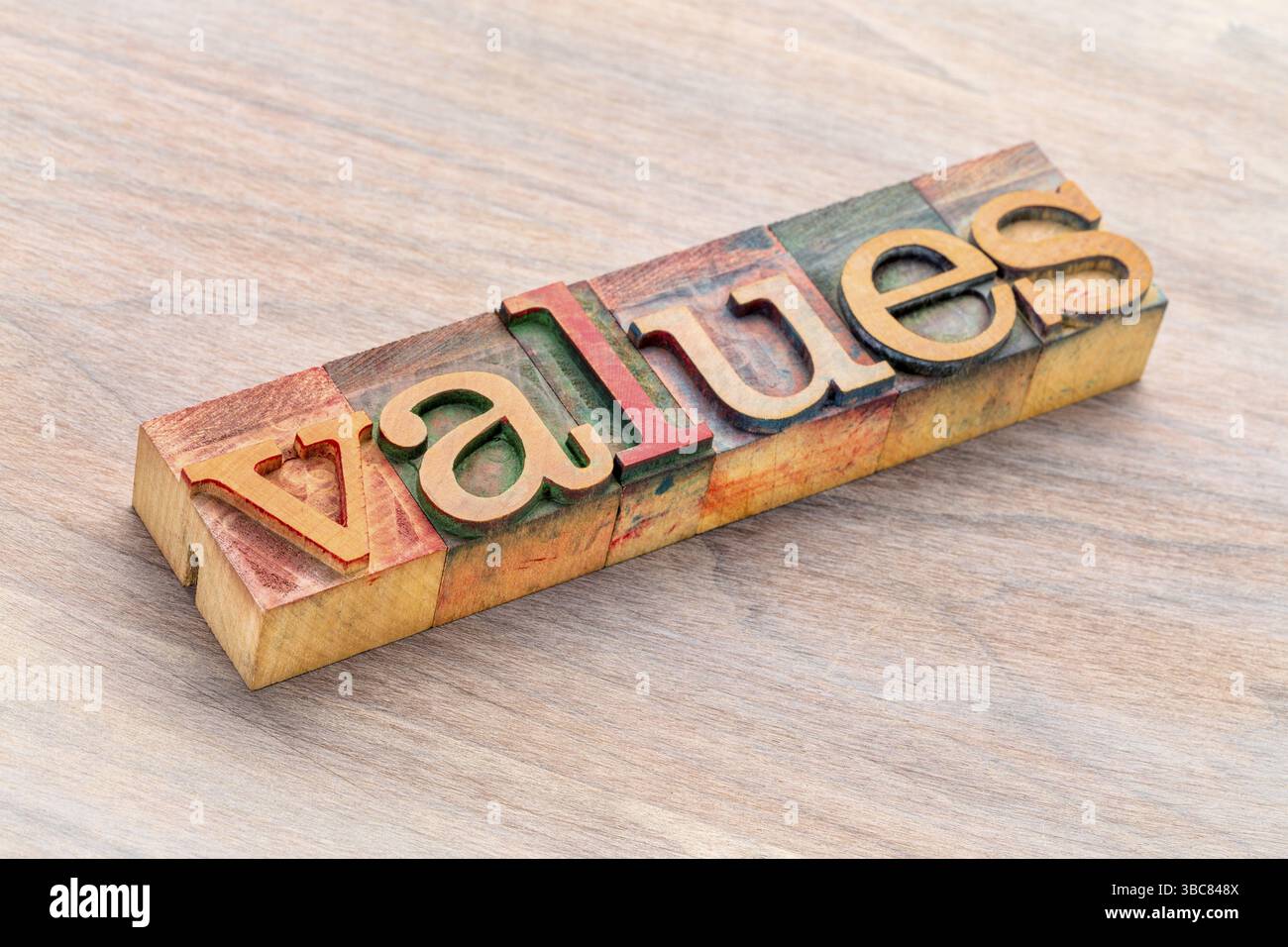 Values word abstract in letterpress wood type blocks stained by color ...