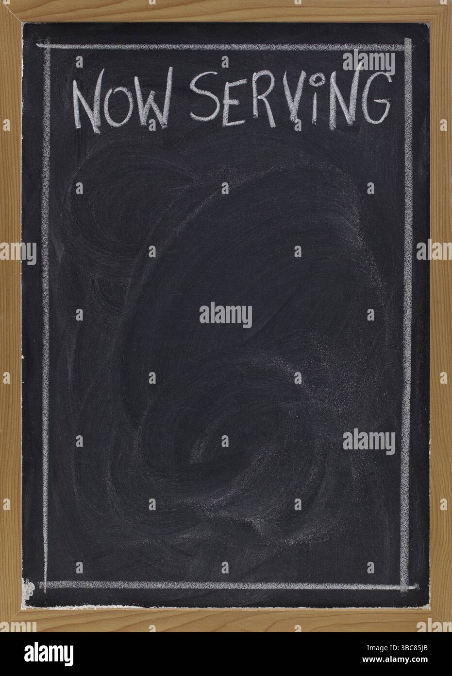 Now serving - white chalk handwriting on blackboard with blank space ...