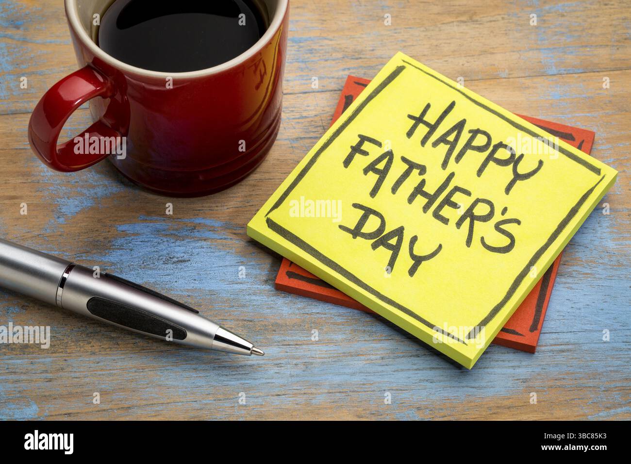 Happy father's day - handwriting in black ink on a sticky note with a ...