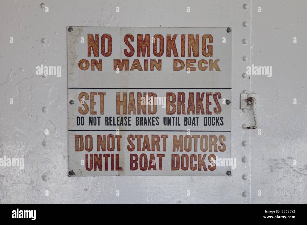 No smoking and instructions sign on a white still wall of old ferry ...