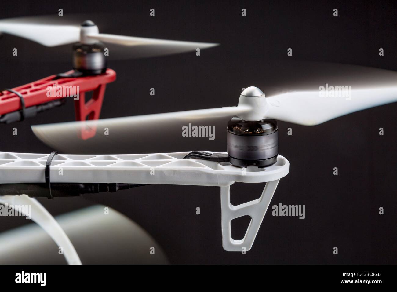 Rotating propellers of a hexacopter drone against black background ...