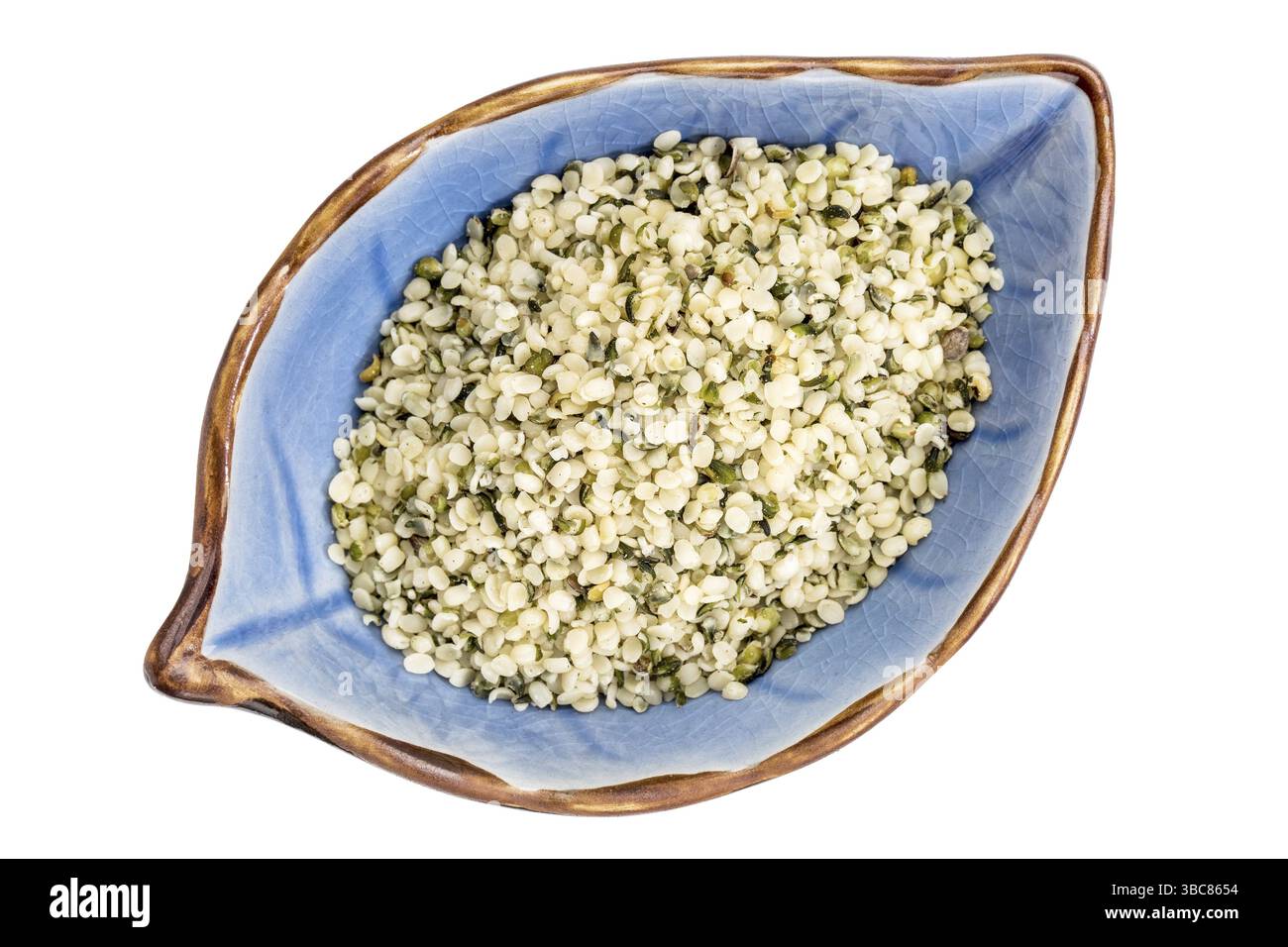 Hemp seed hearts on an isolated leaf shaped ceramic bowl, top view ...