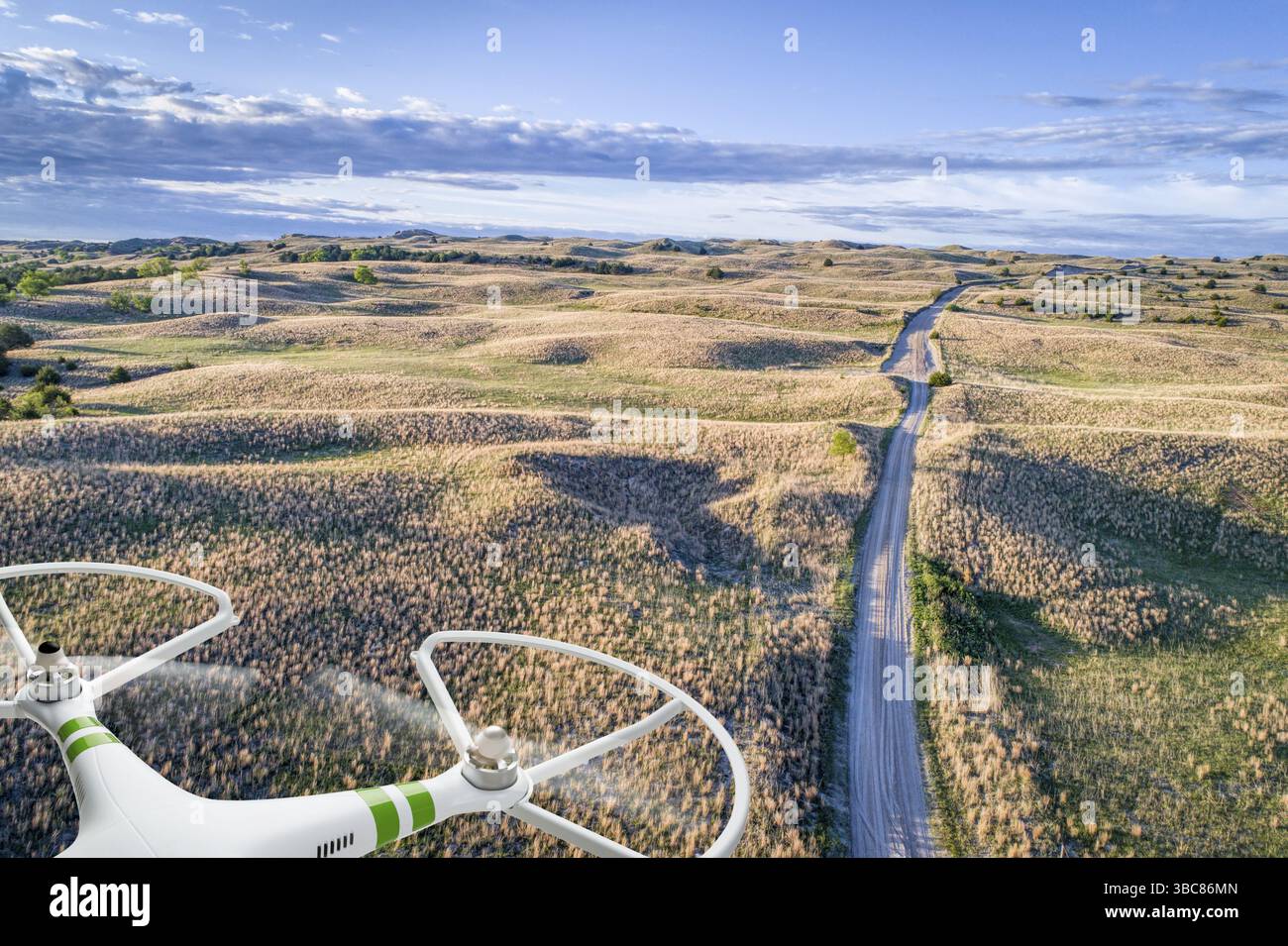Aerial view of a farm road in Nebraska Sand Hills with a flying drone ...